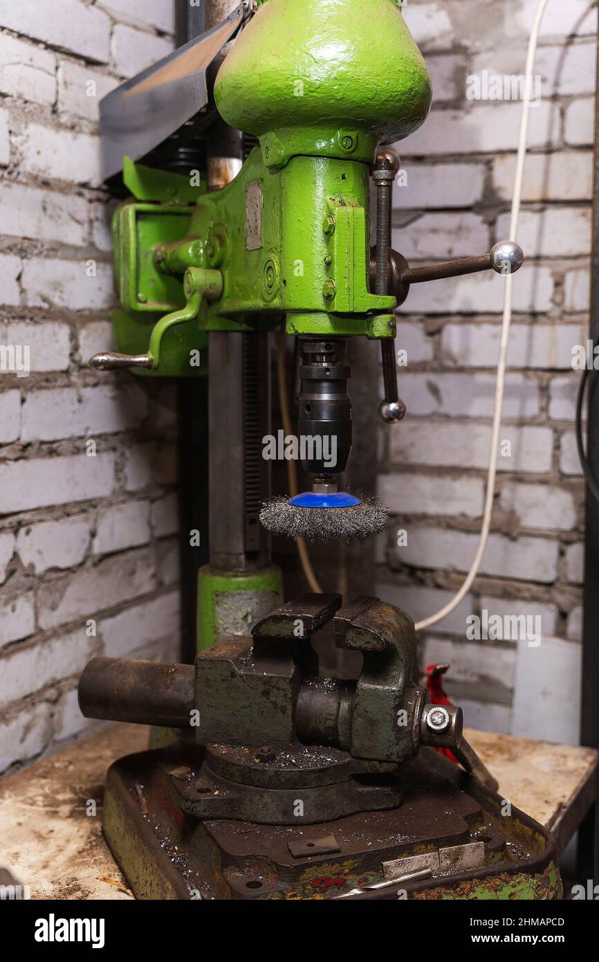 An old reliable drilling machine in the workshop, metalworking, machine ...