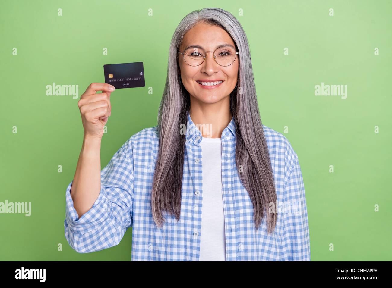 Photo of optimistic elder grey hairdo lady show card wear eyewear plaid ...