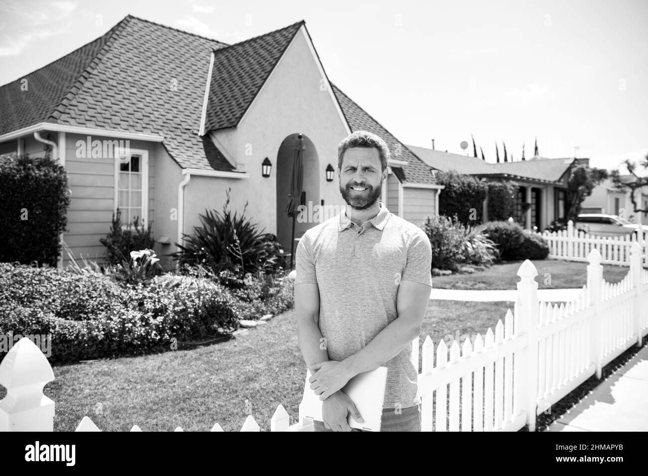 Man standing outside new home. Happy and handsome businessman Stock ...