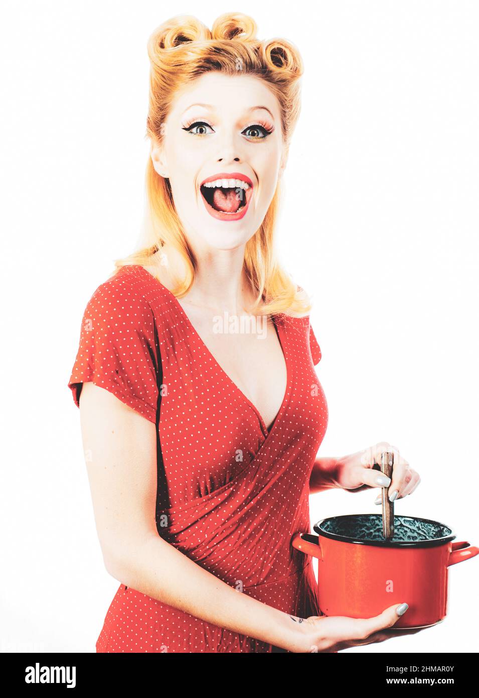 Funny woman winking in the kitchen and cooking Stock Photo - Alamy