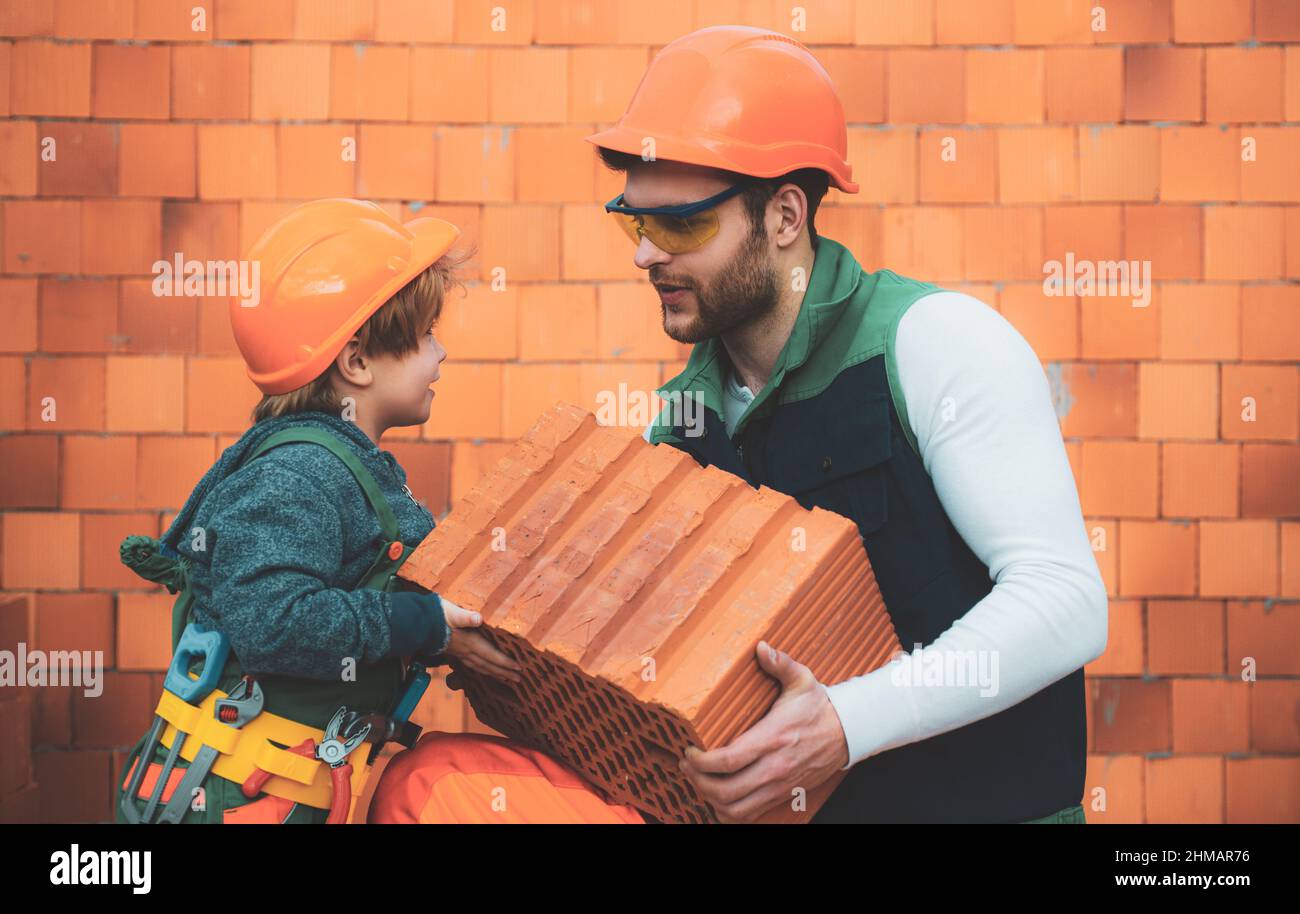 Brother helping at workshop. Bricklayer make masonry, builder work with ...