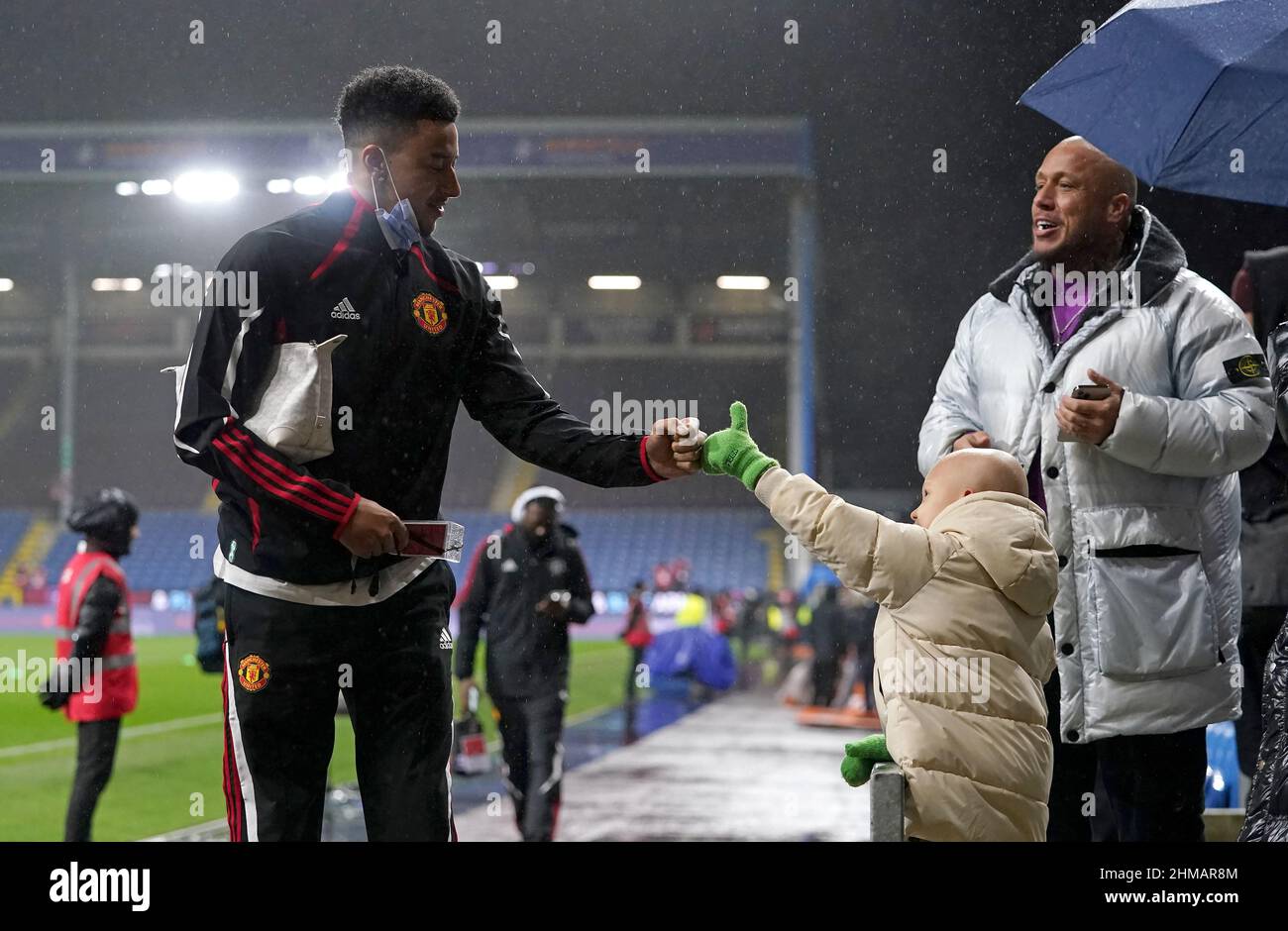 Manchester United's Jesse Lingard greets a young fan while arriving at ...