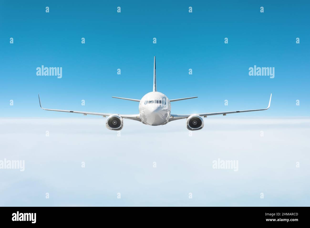 Airplane flies in the sky above a dense layer of clouds Stock Photo - Alamy