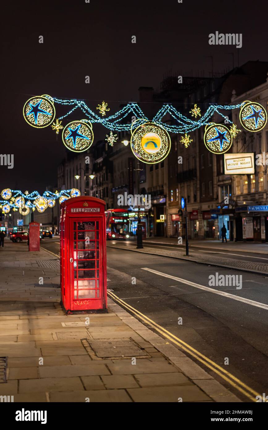 The red telephone box in London, Christmas illumination at background ...