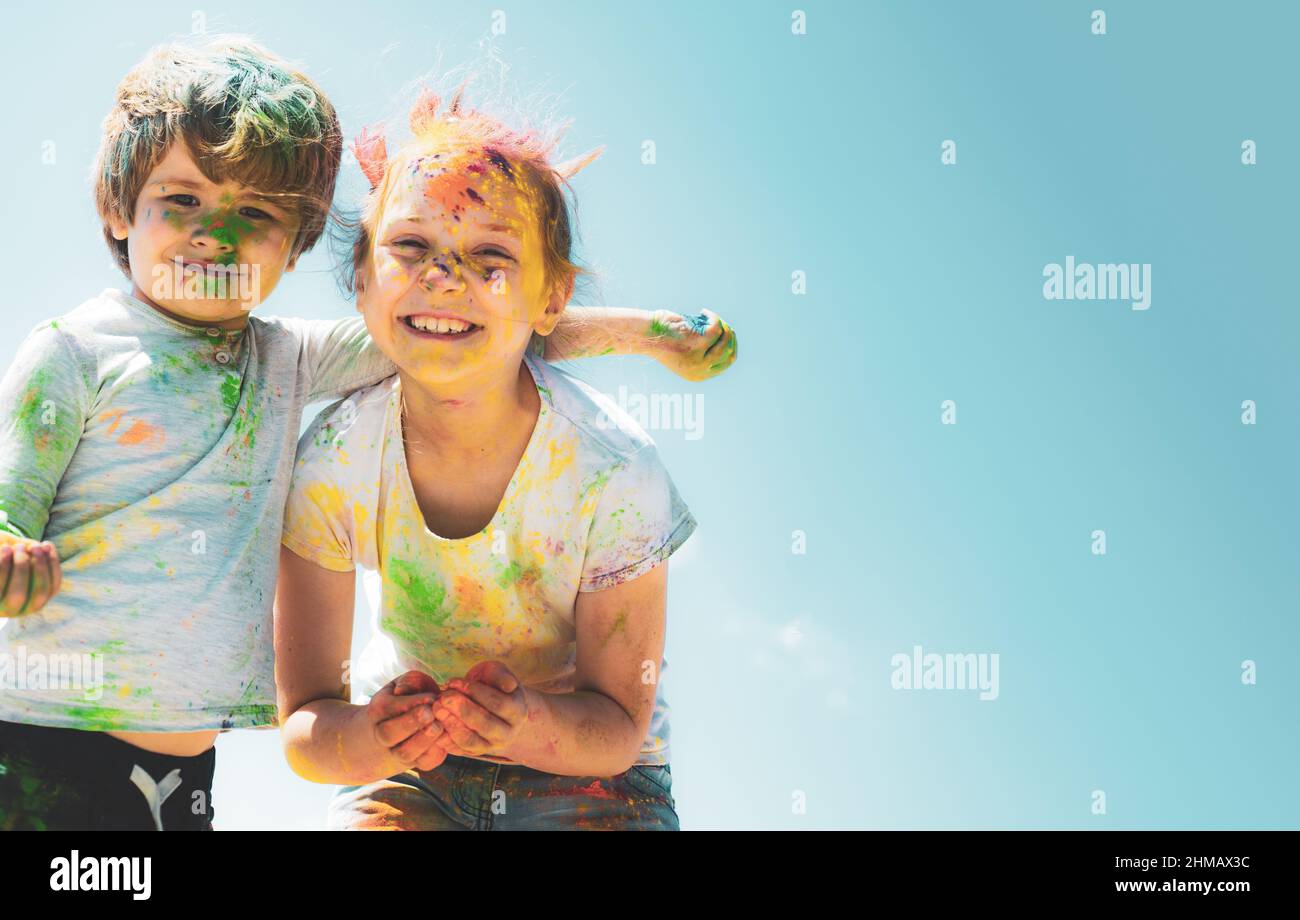 Two kids with face smeared with colors Stock Photo - Alamy