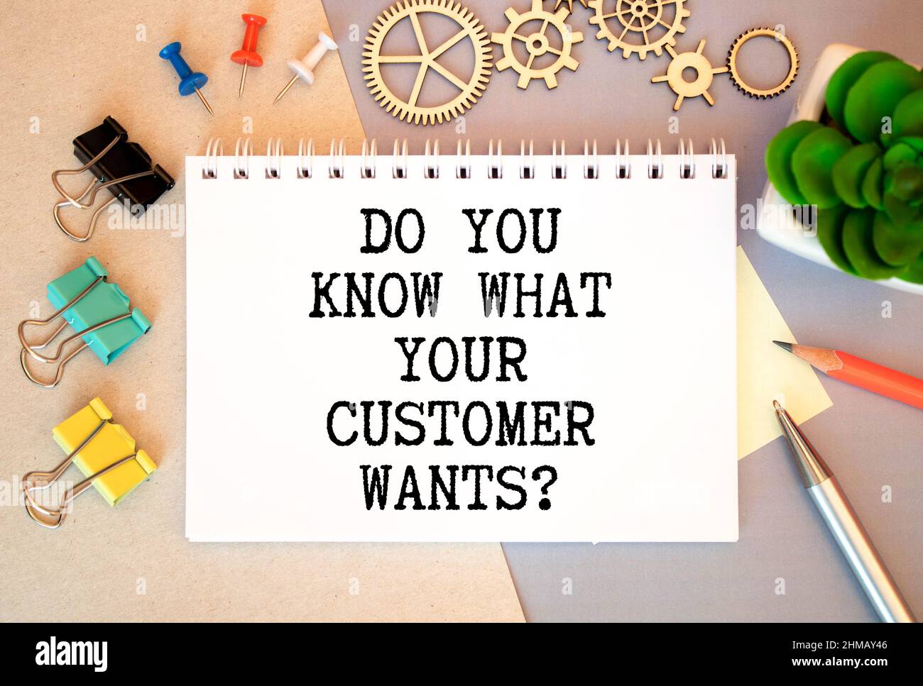 Notebook With Text Do You Know Your Customer On A Table With Sticks Colored Paper Clips And