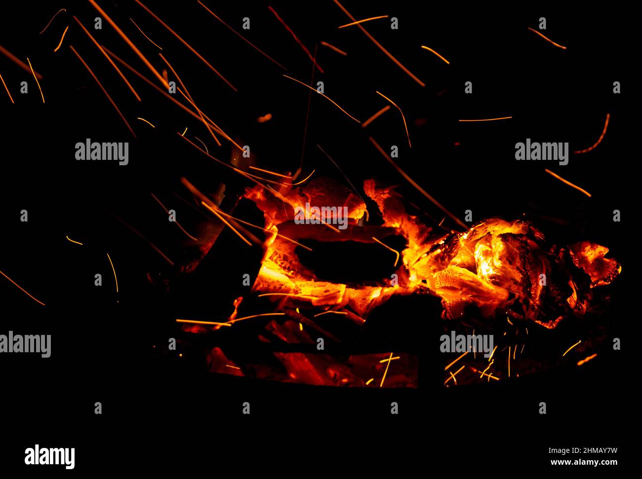 Burning charcoal embers throwing some sparks into the air. Fire to make ...