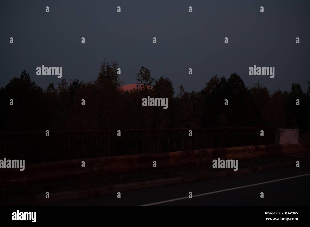A vibrant sunset lights up the New Safe Confinement which seals the ...