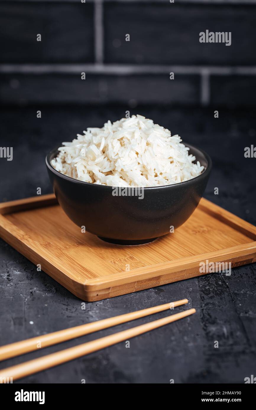 Basmati rice, cooked and raw in different bowls and placed on different ...