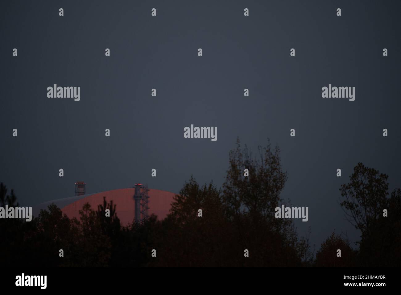 A vibrant sunset lights up the New Safe Confinement which seals the ...