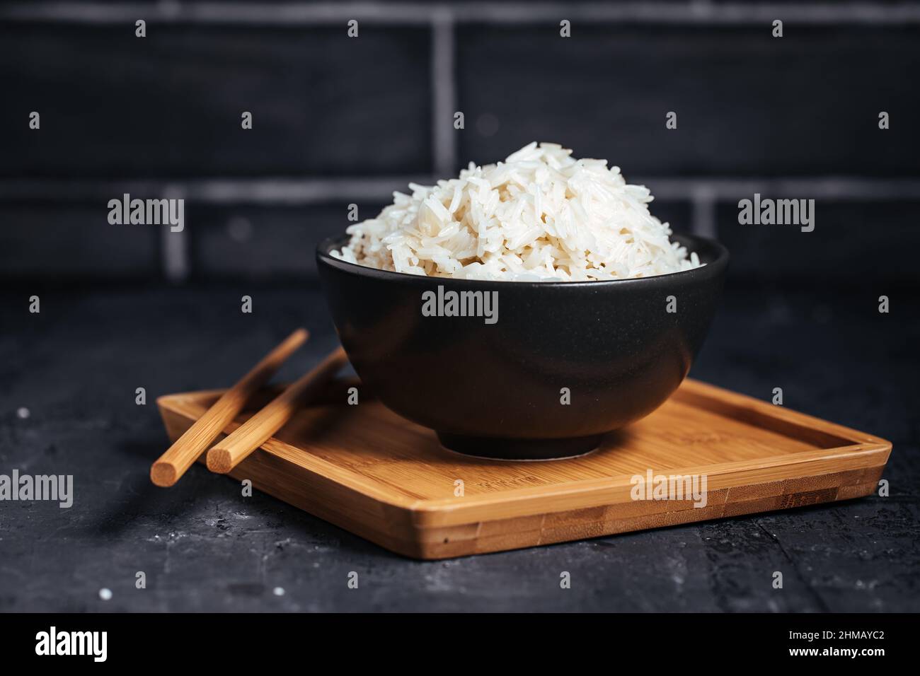 Basmati rice, cooked and raw in different bowls and placed on different ...