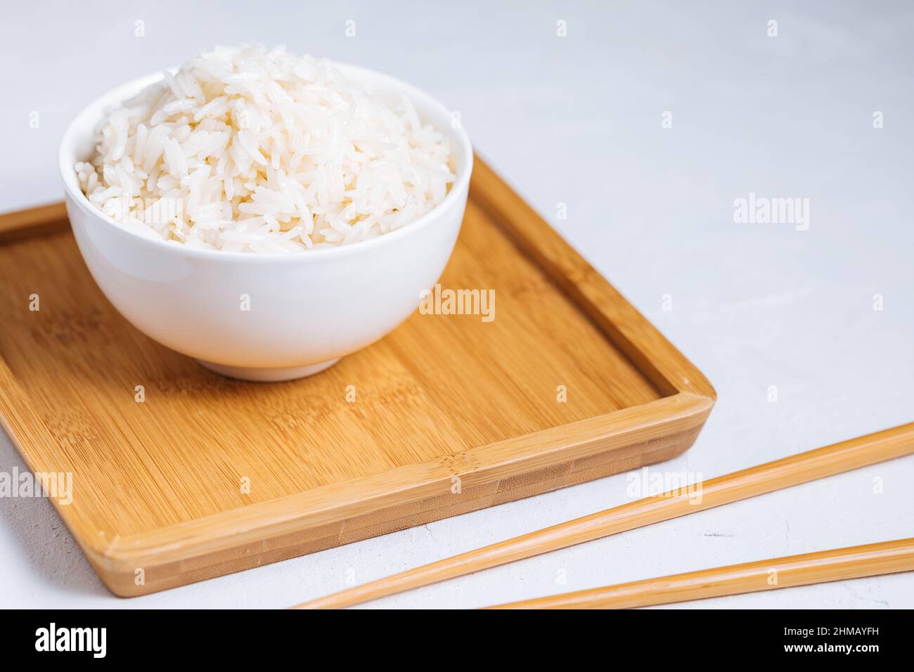 Basmati rice, cooked and raw in different bowls and placed on different ...