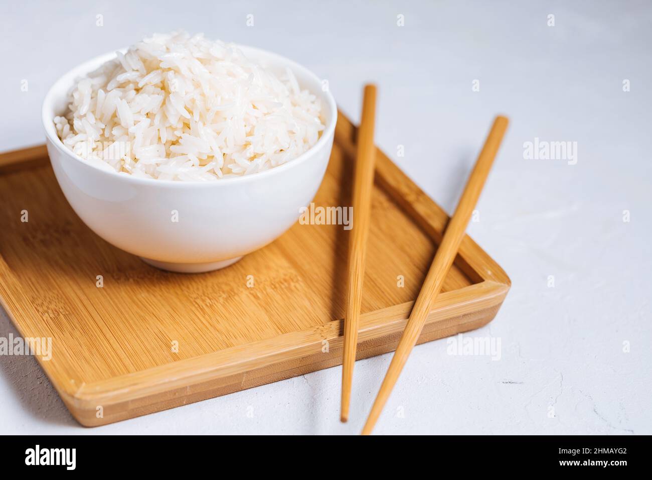 Basmati rice, cooked and raw in different bowls and placed on different ...