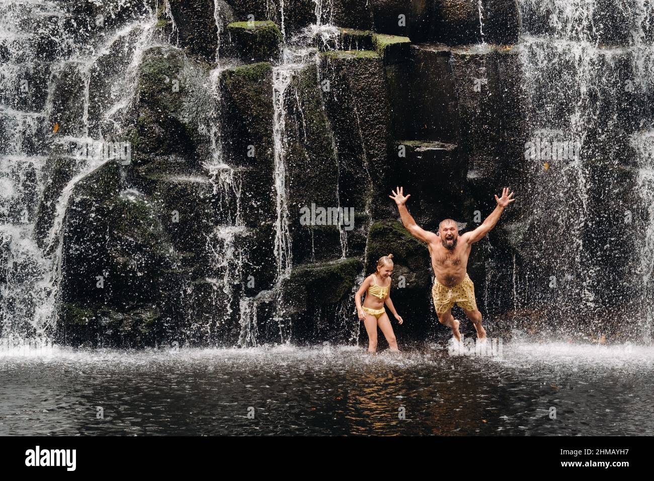 Many people bathe in a waterfall. People at the cave waterfall. Bathing ...