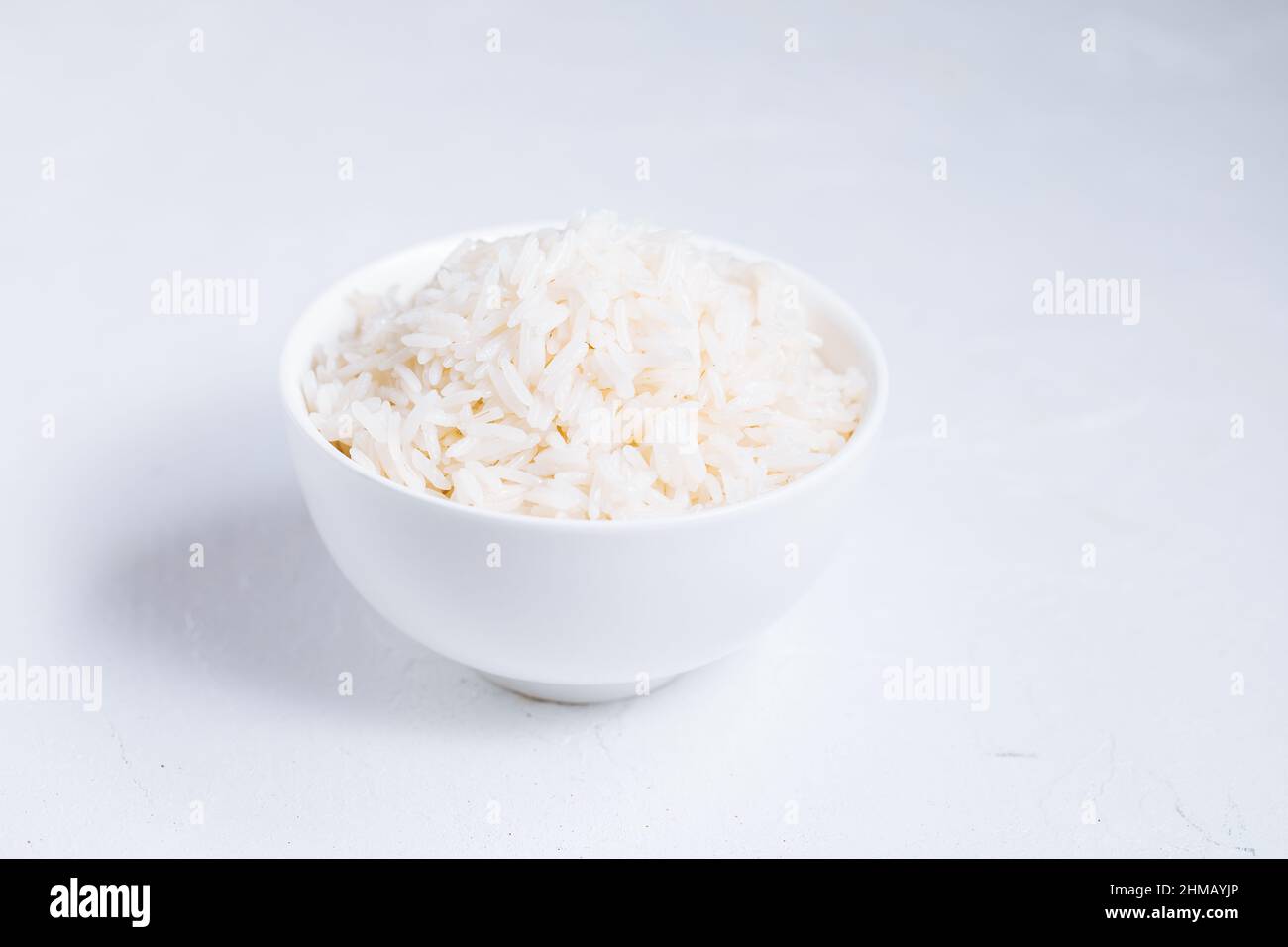 Basmati rice, cooked and raw in different bowls and placed on different ...
