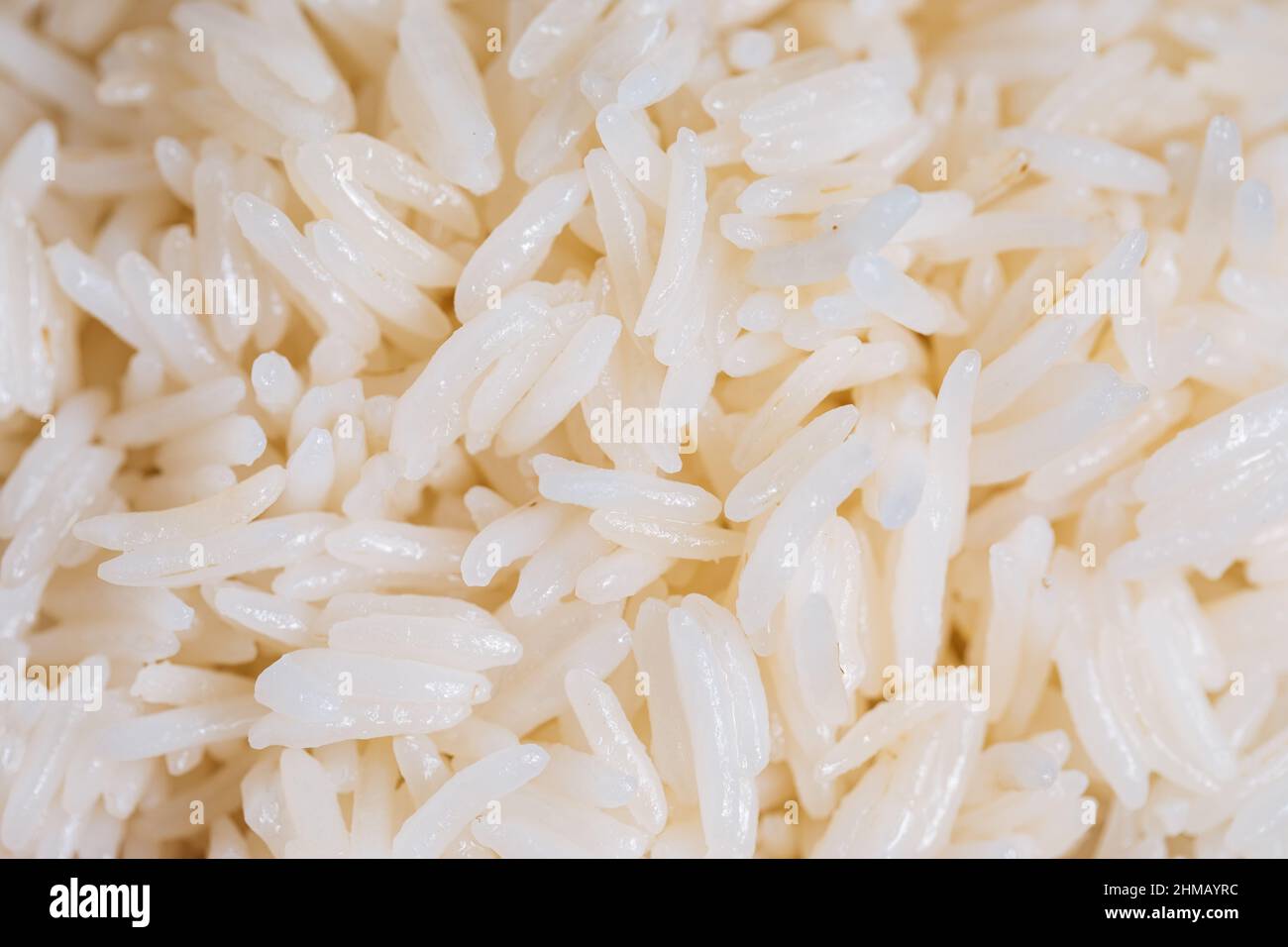 Basmati rice, cooked and raw in different bowls and placed on different ...