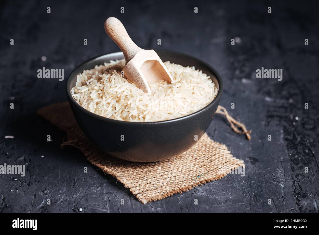Basmati rice, cooked and raw in different bowls and placed on different ...