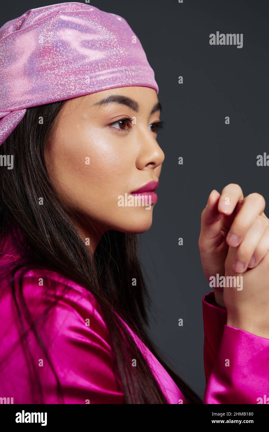 pretty woman in a pink mini dress pink headscarf luxury close-up studio model Stock Photo - Alamy
