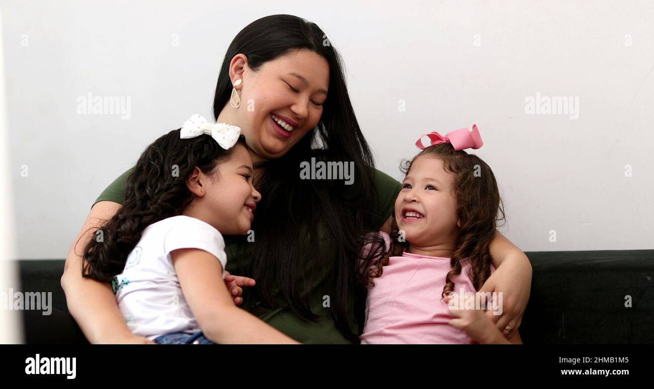 Asian mom with hispanic mix children interaction Stock Photo - Alamy