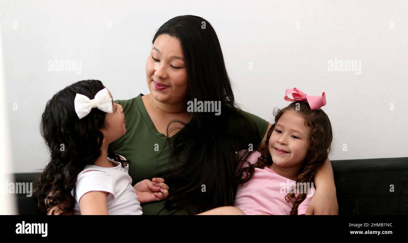Asian mom with hispanic mix children interaction Stock Photo - Alamy