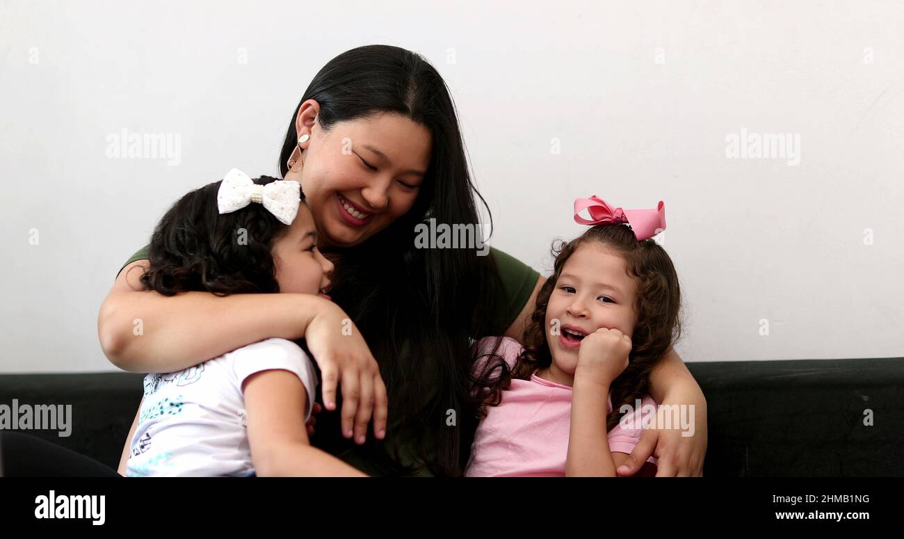 Asian mom with hispanic mix children interaction Stock Photo - Alamy