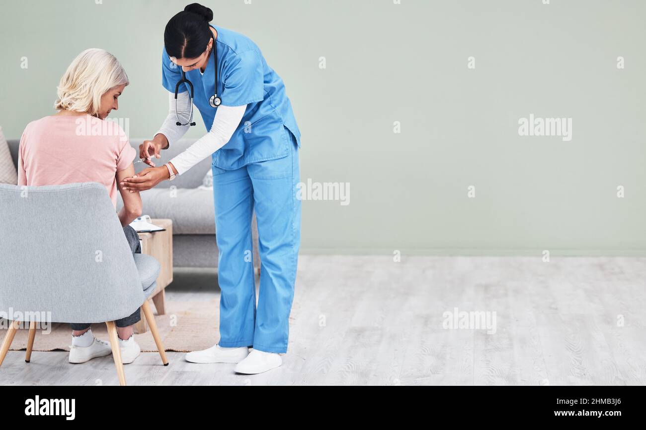 This will be quick. Shot of a female nurse giving her patient an ...