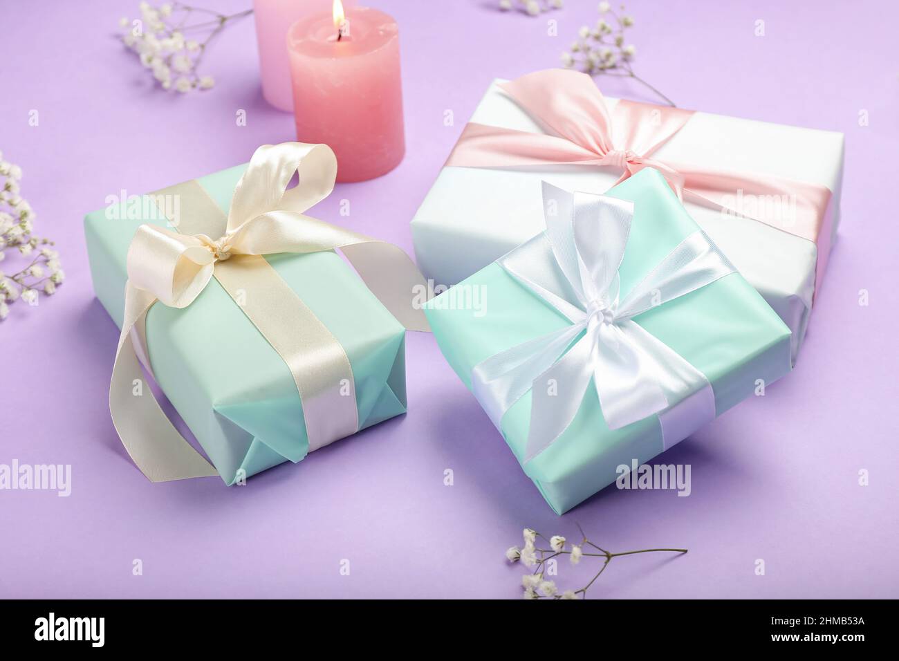Beautiful gift boxes on lilac background Stock Photo - Alamy