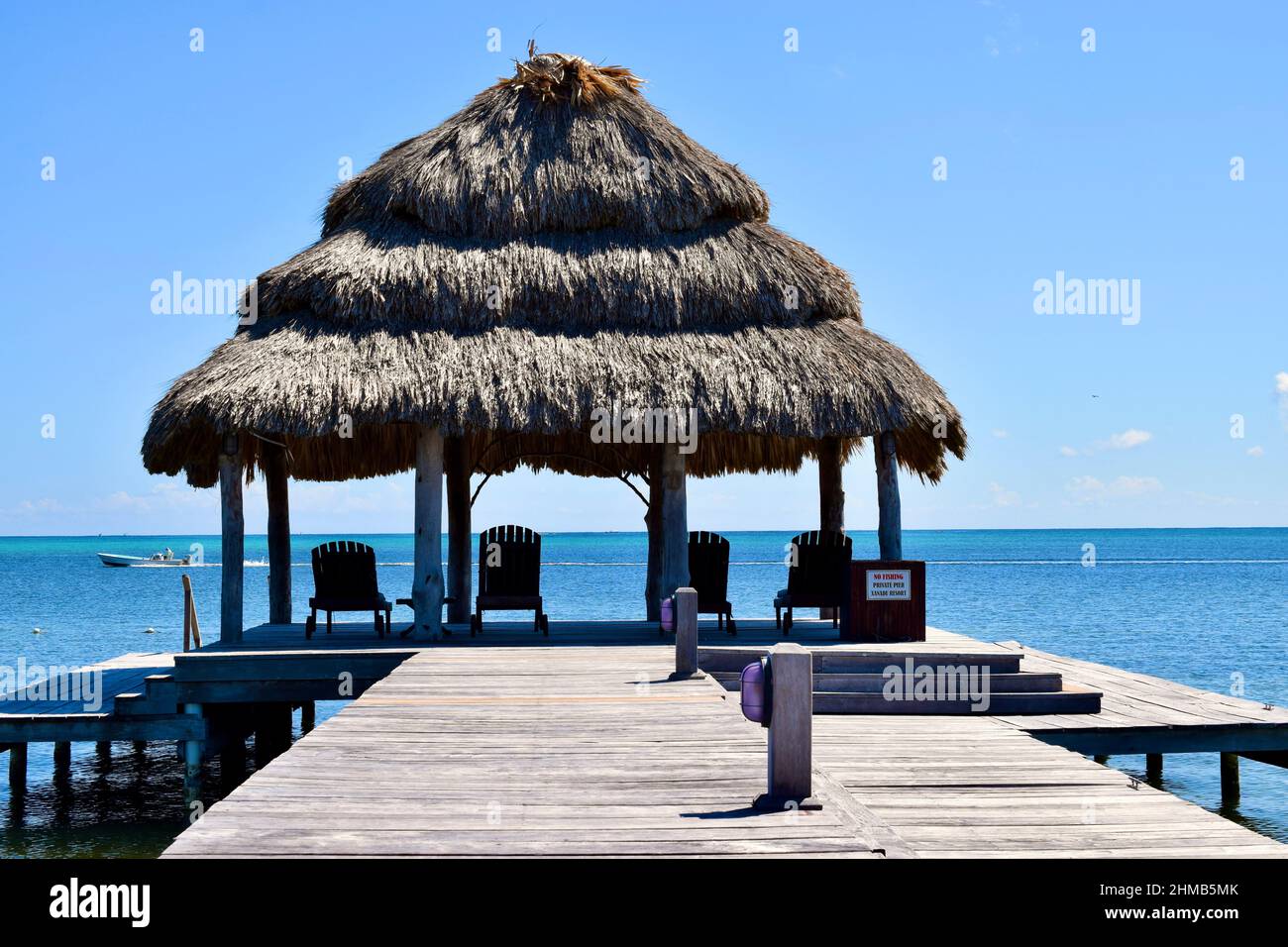 A palapa over the water at a beach hotel facing the Caribbean Sea with ...