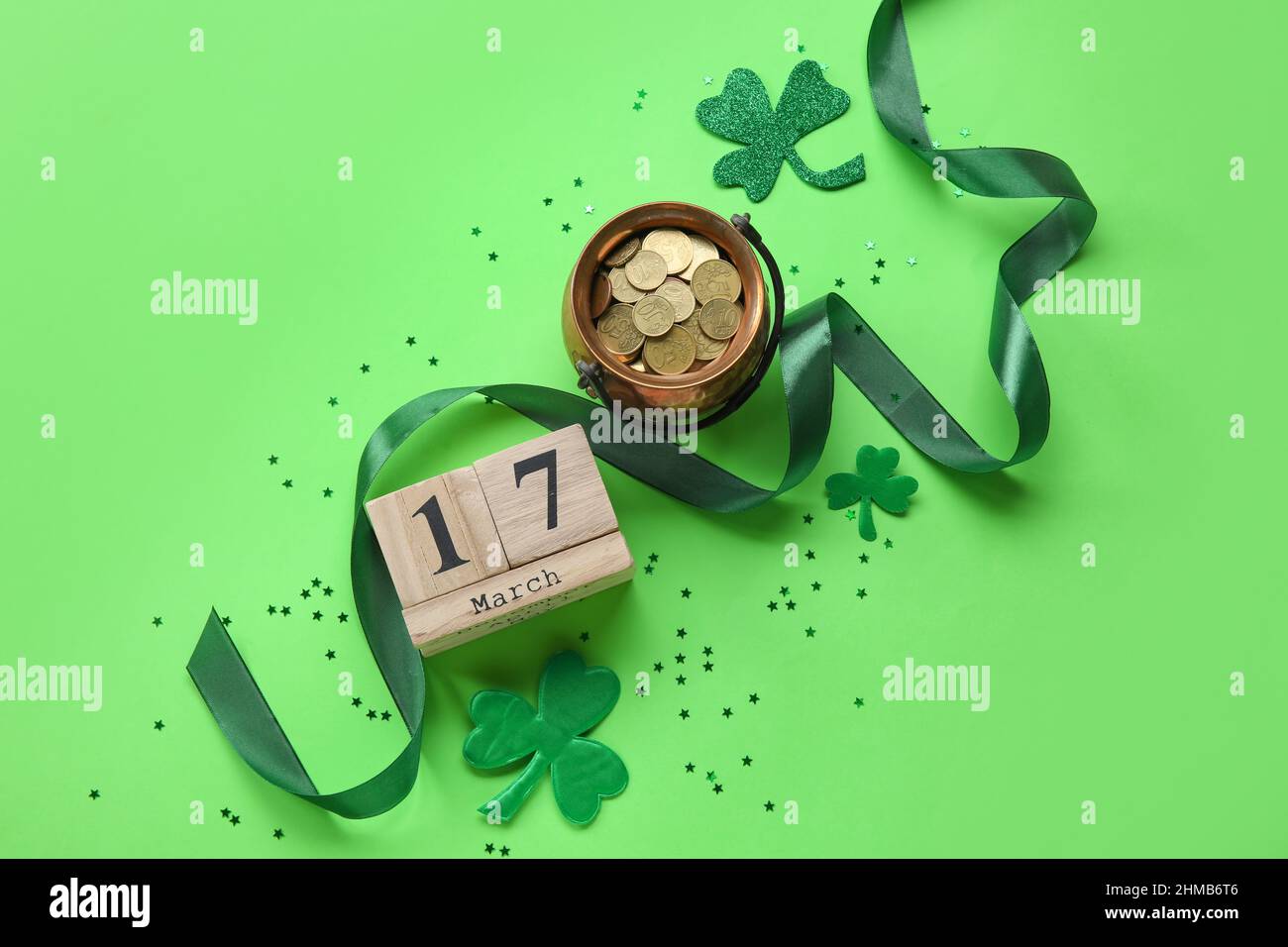 Leprechaun pot with golden coins and calendar with date of St. Patrick ...