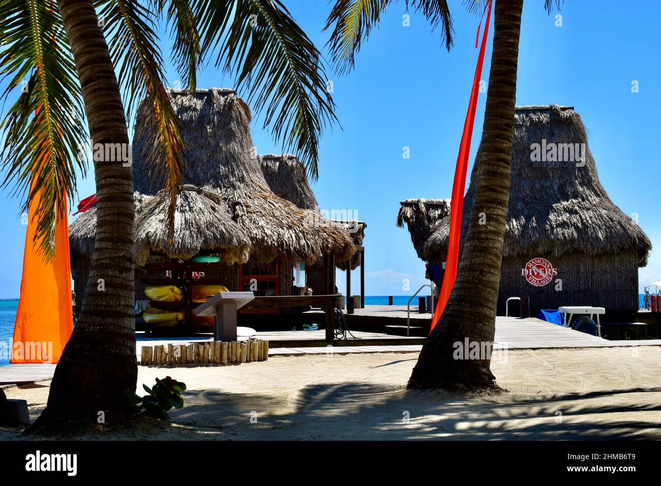 Polynesian-style tiki huts along a pier at a beach resort in San Pedro ...