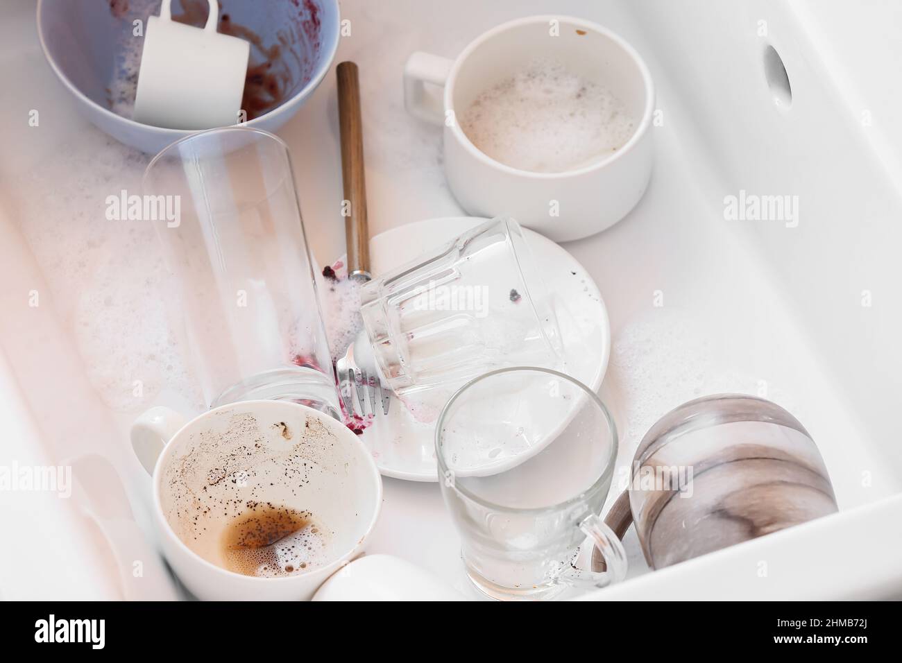 Dirty dishes in ceramic sink, closeup Stock Photo - Alamy