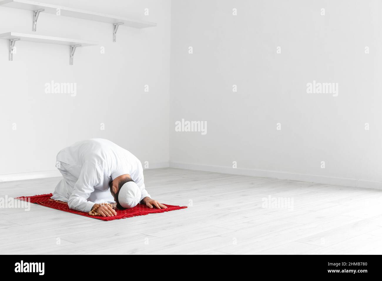 Praying young Muslim man at home Stock Photo - Alamy