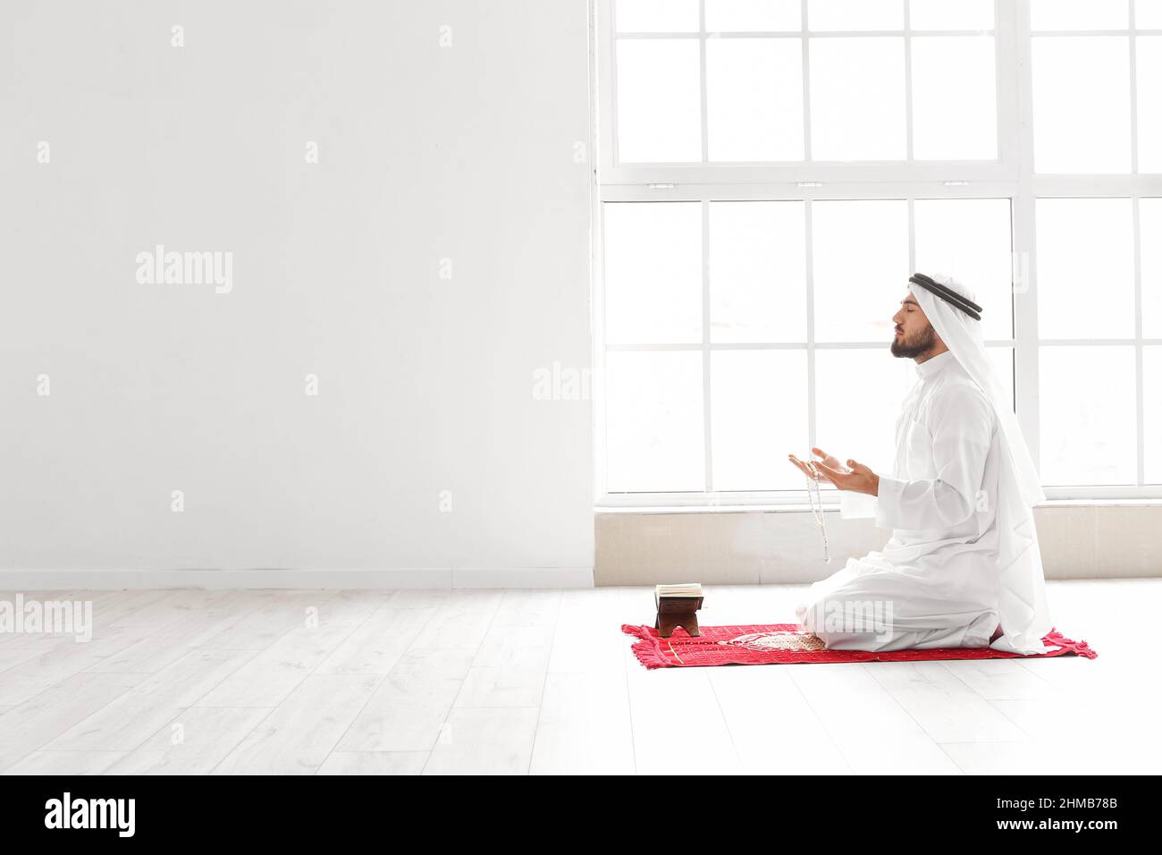 Praying young Muslim man at home Stock Photo - Alamy