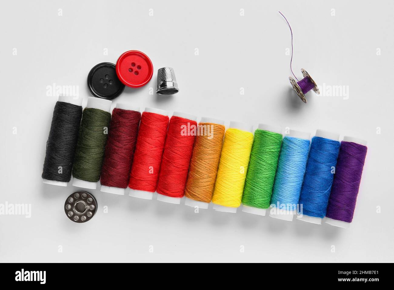 Thread spools and buttons on white background Stock Photo - Alamy