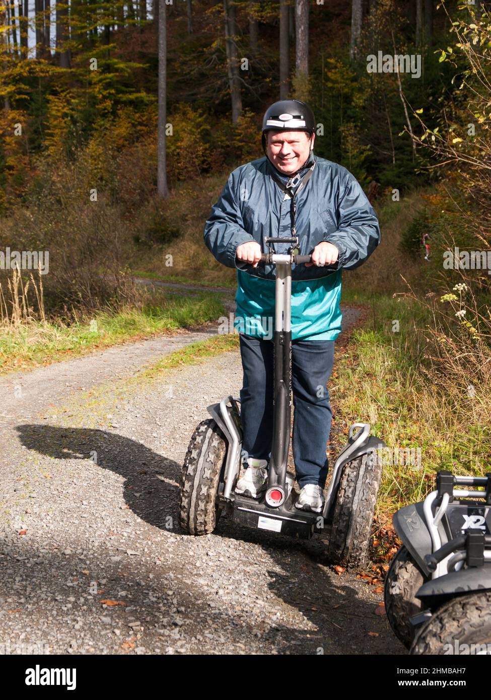 Mature gentleman riding on segway Stock Photo - Alamy