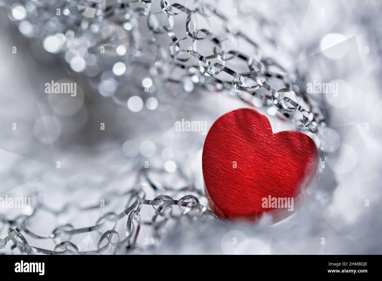 Red heart in silver chains. Photo Stock Photo - Alamy