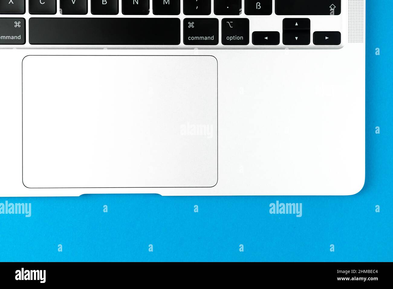 Laptop keyboard flat lay blue background. Office workspace table ...