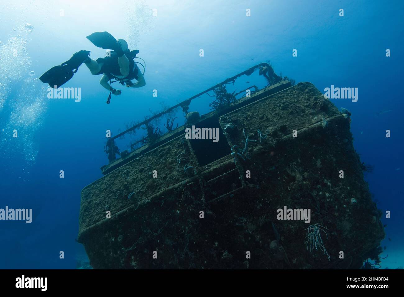 divers enjoying a deep wreck ship Stock Photo - Alamy