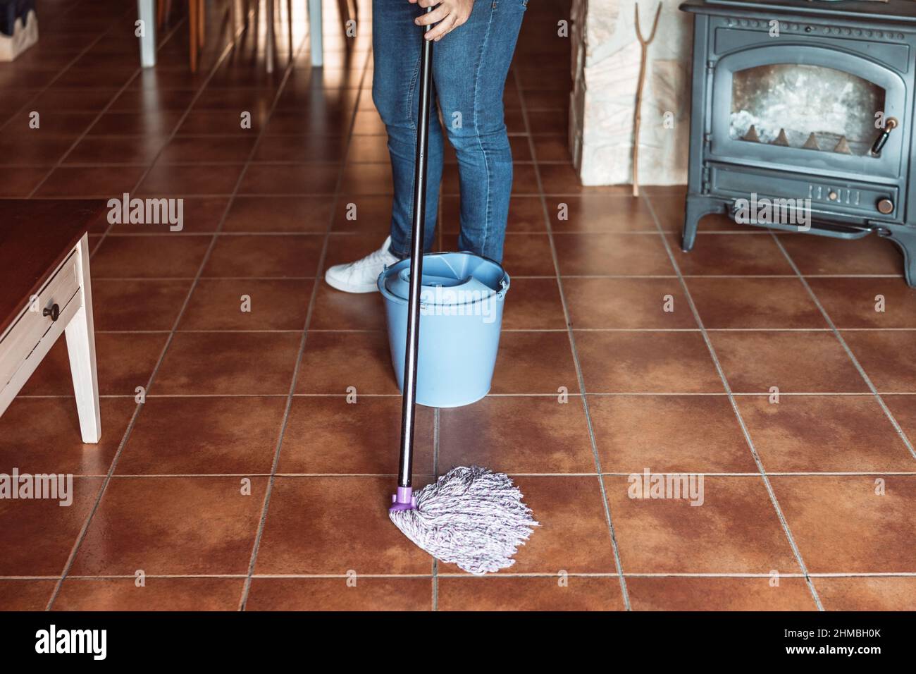 A man scrubbing the living room floor Stock Photo - Alamy