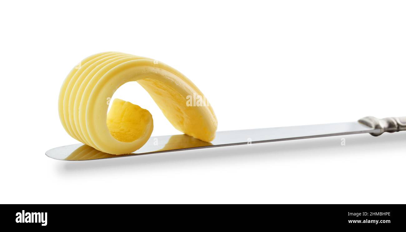 curl of fresh butter on a knife isolated on white background Stock ...