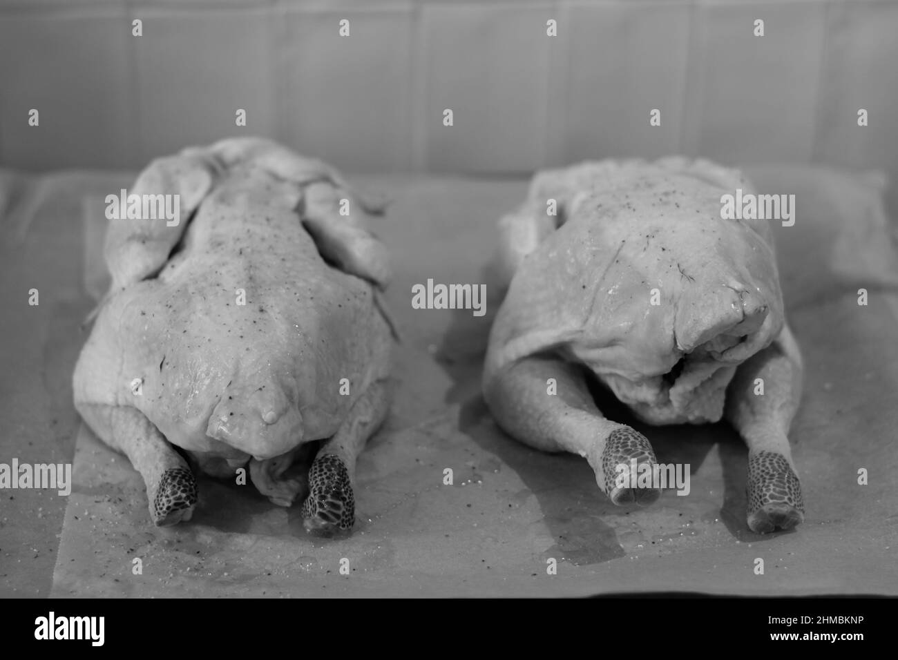 Grayscale of two dressed chicken on a tray Stock Photo - Alamy