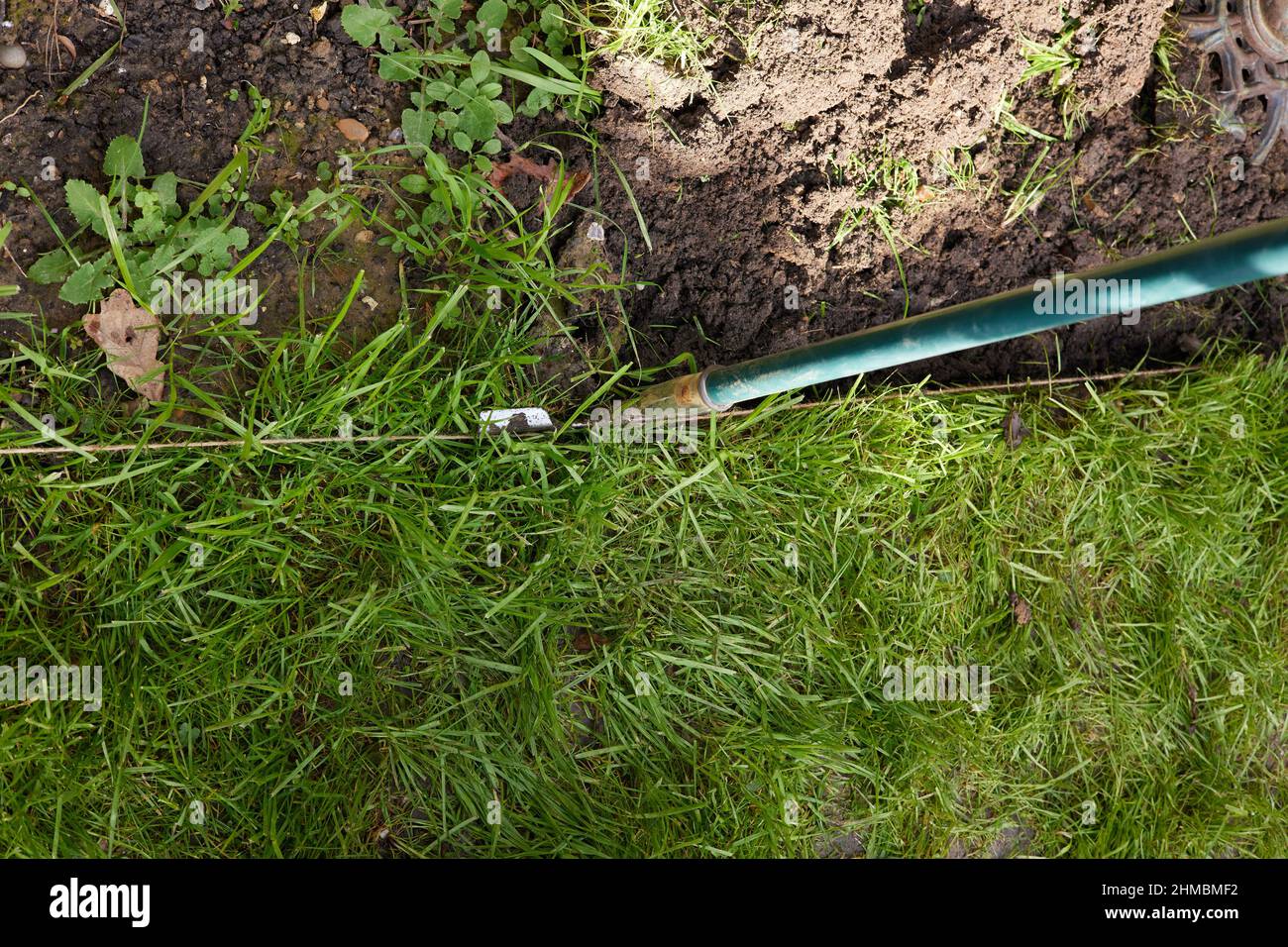 Close up of a lawn edger used to separate the turf from the soil in a ...