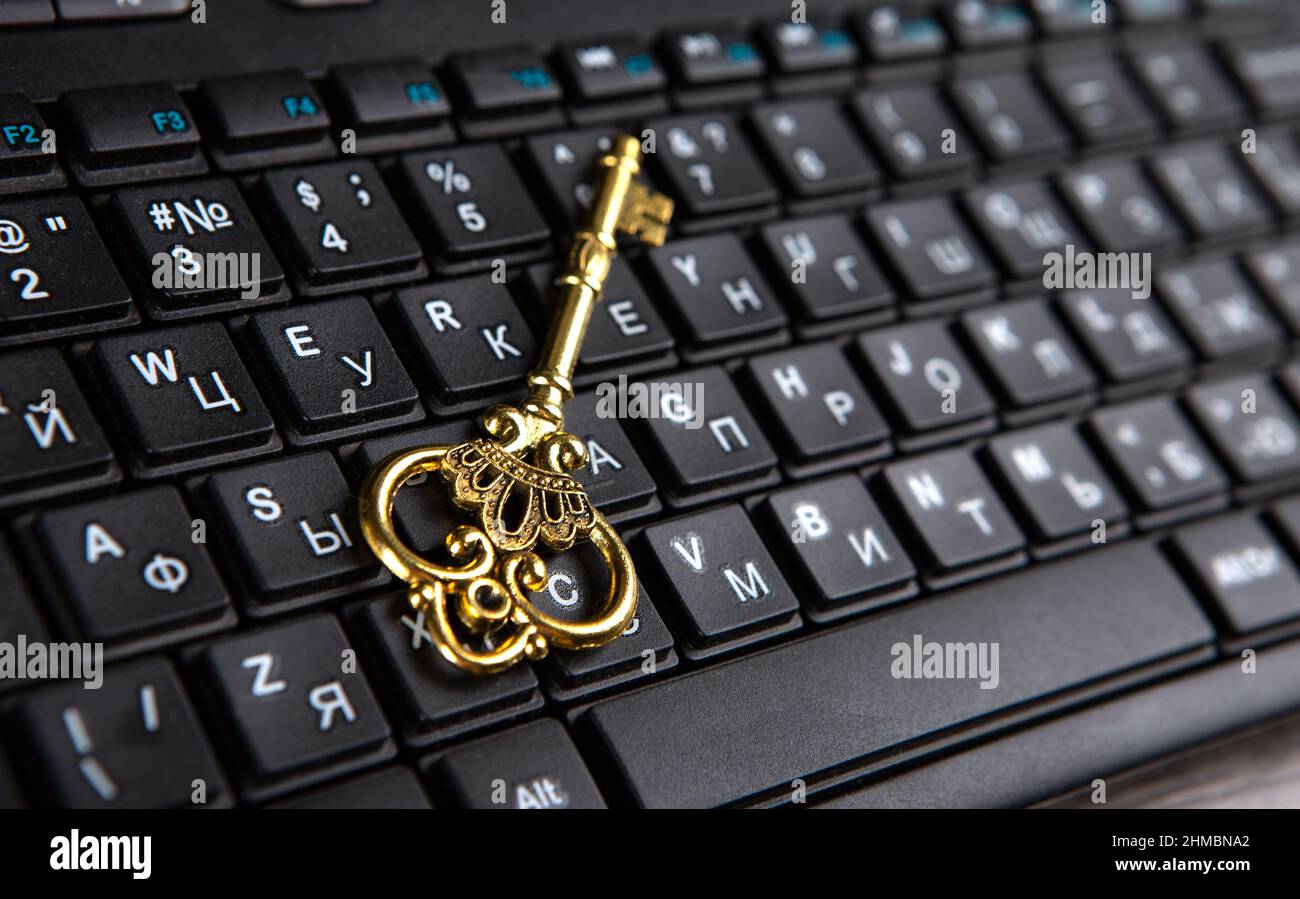golden key symbol on black computer keyboard closeup Stock Photo - Alamy