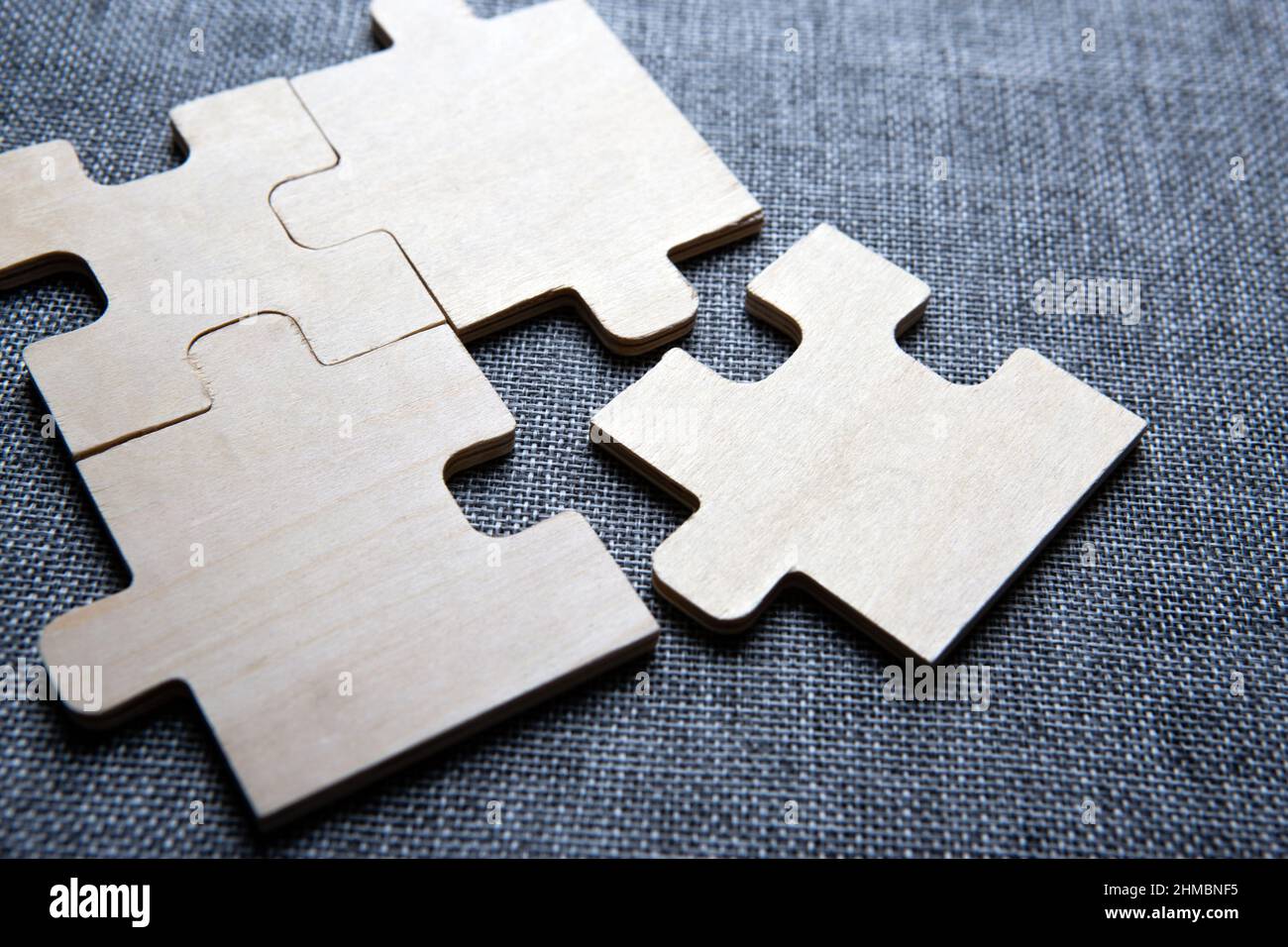 Three puzzle pieces in a row on a textile background closeup Stock ...