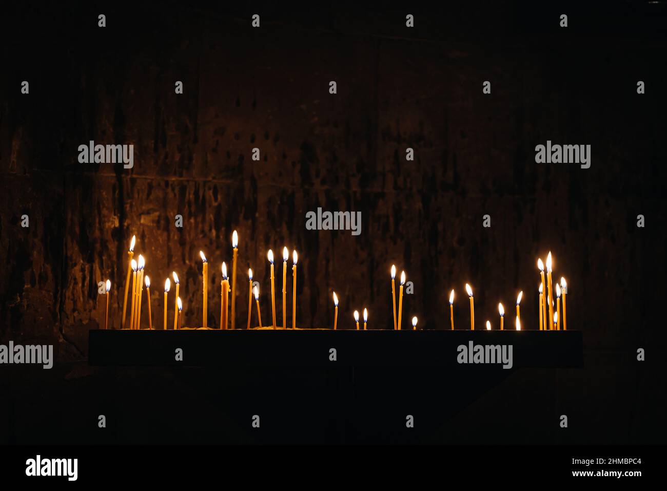 Shot of group of lighted candles in church Stock Photo - Alamy