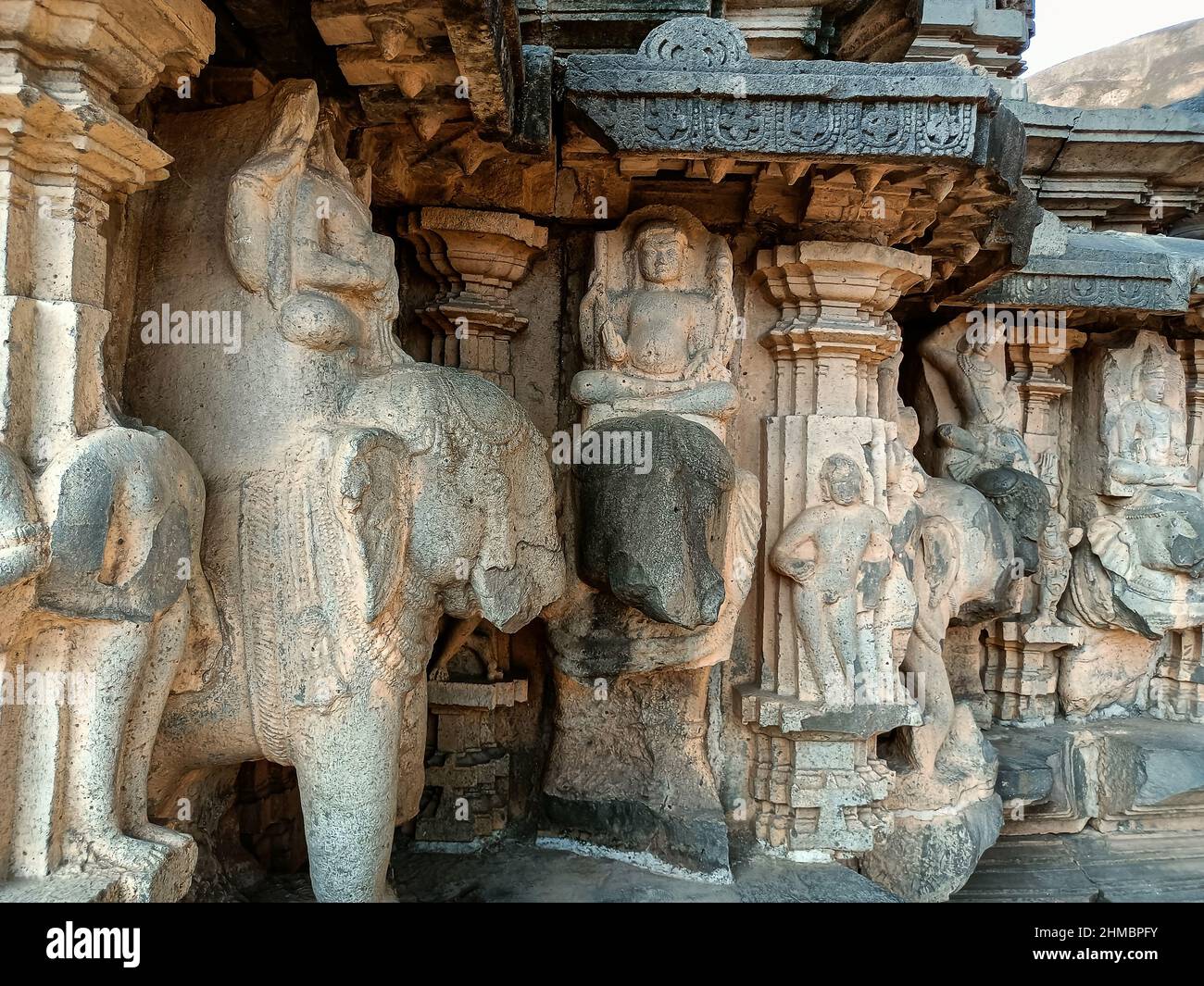 Ruined ancient sculpture of the Hindu trinity god sitting on an ...