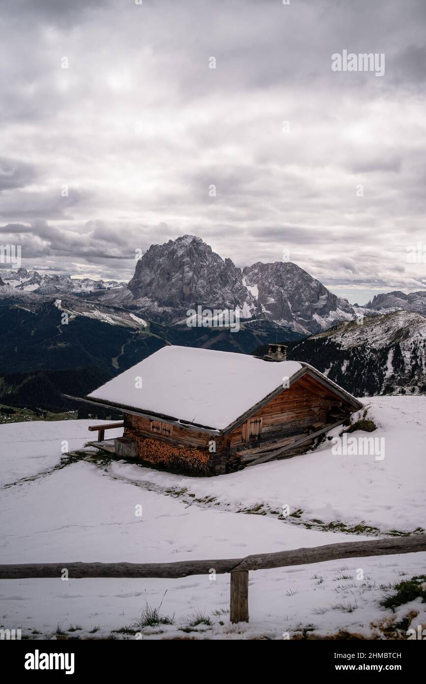 Vertical shot of a small hut in the snow with mountains Stock Photo - Alamy