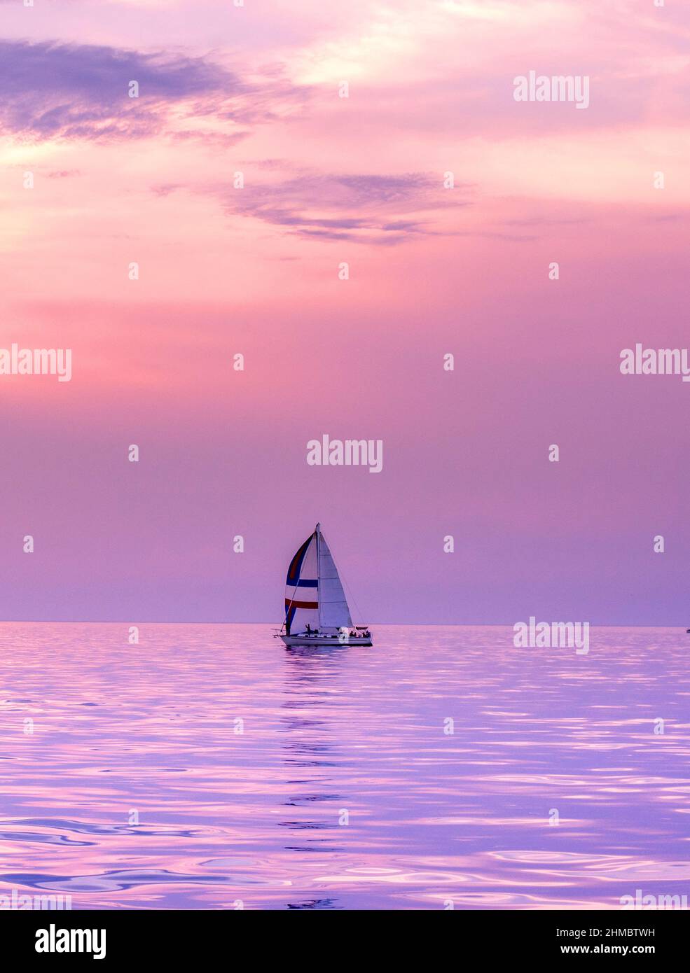 Lone boat on water sunset hi-res stock photography and images - Alamy