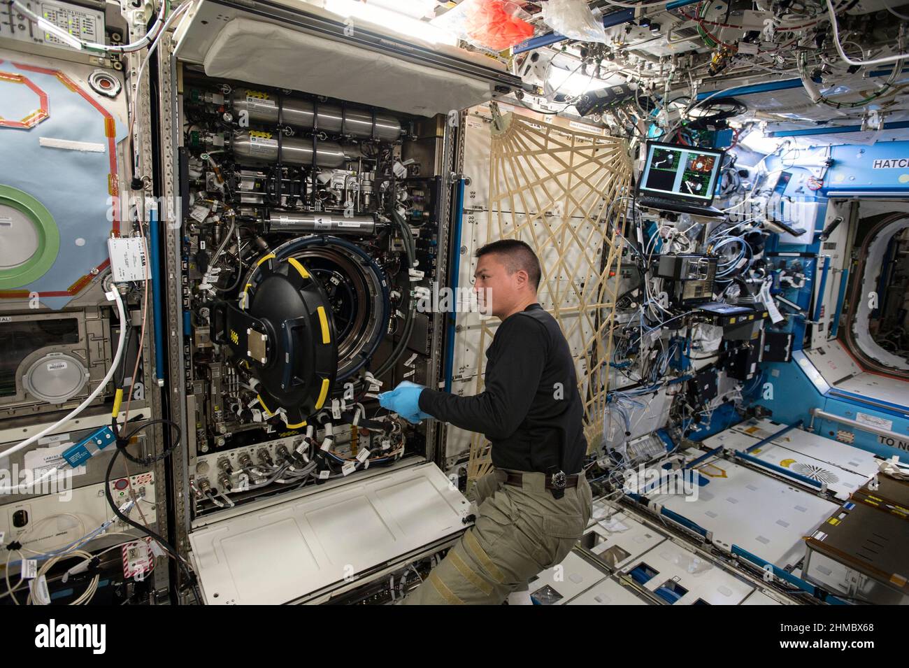 Astronaut replacing items on the ISS Stock Photo - Alamy