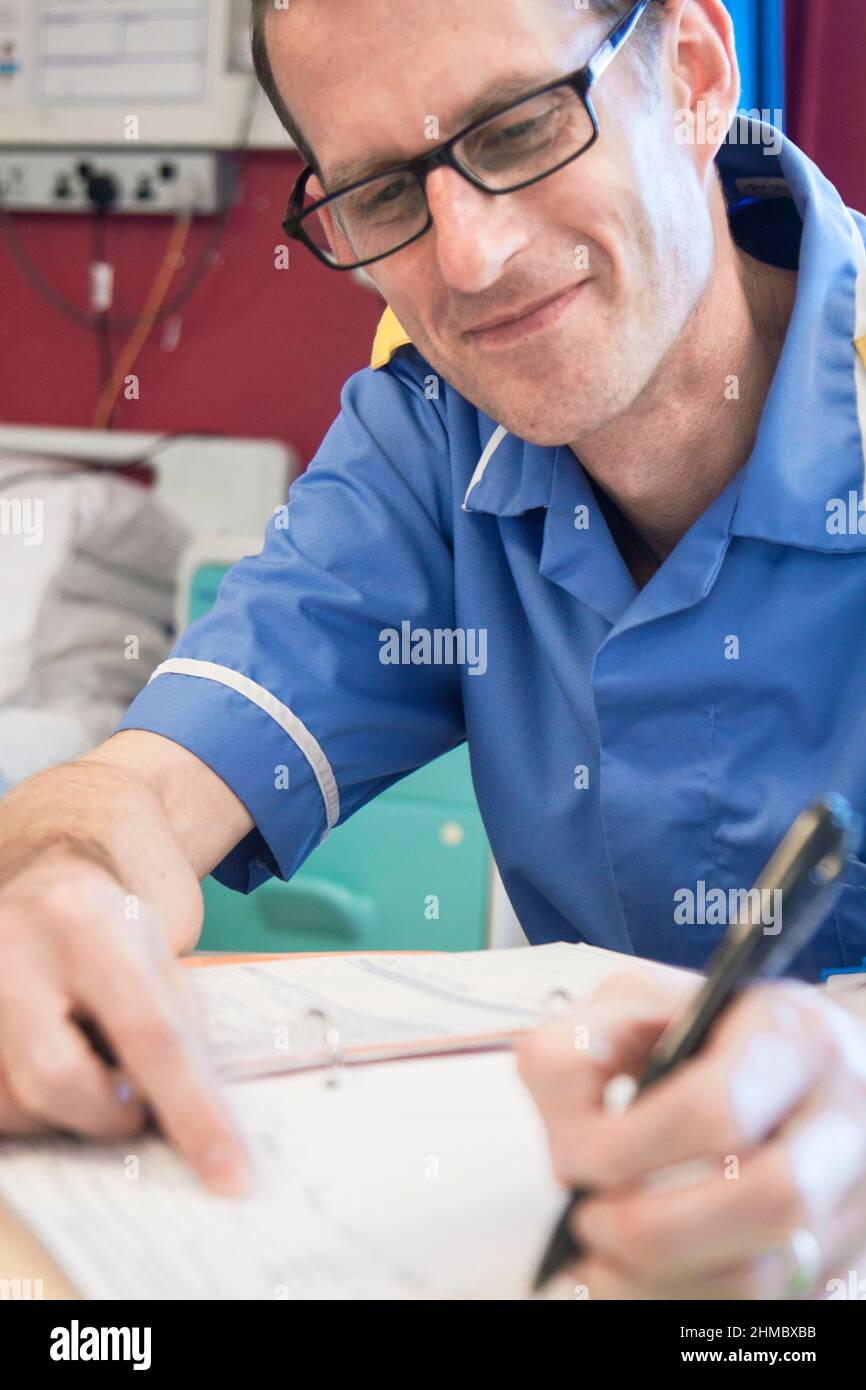 Nurse writing notes Stock Photo - Alamy